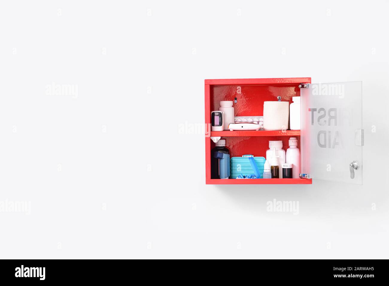 Wall mounted first aid kit on light background Stock Photo - Alamy