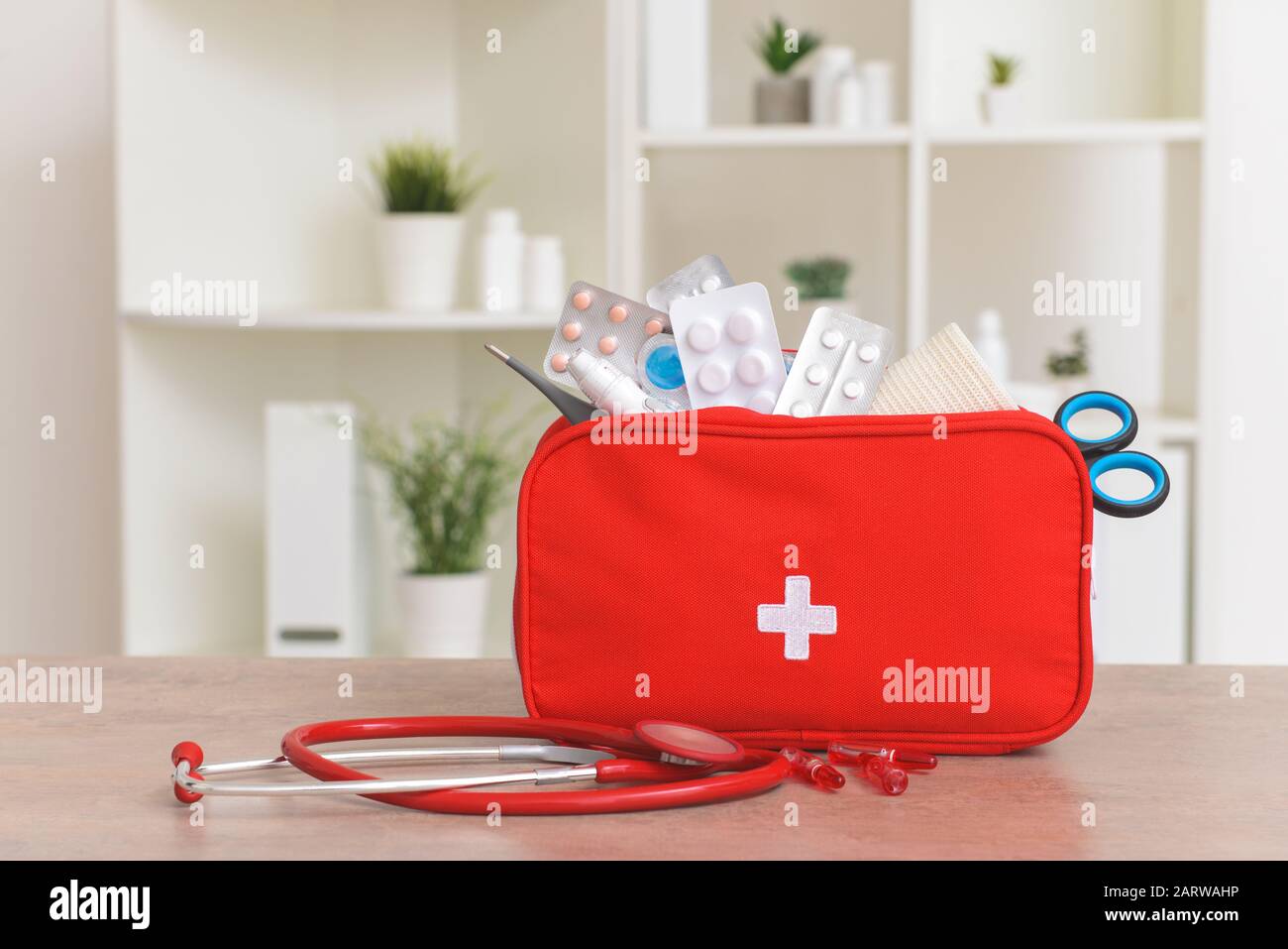 First aid kit on table in clinic Stock Photo - Alamy