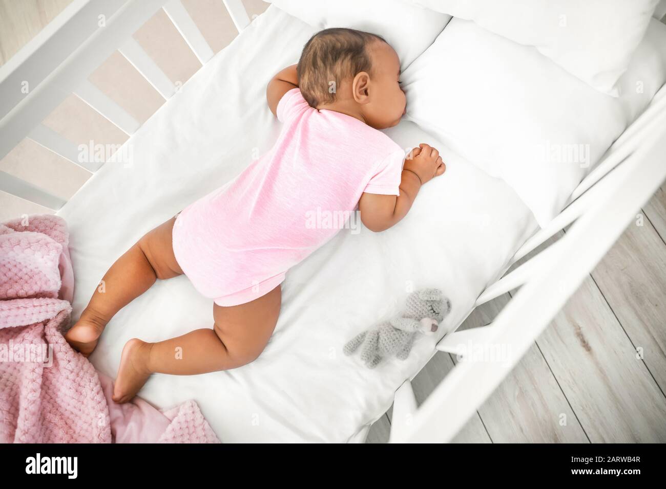Little African-American baby sleeping in bed Stock Photo - Alamy