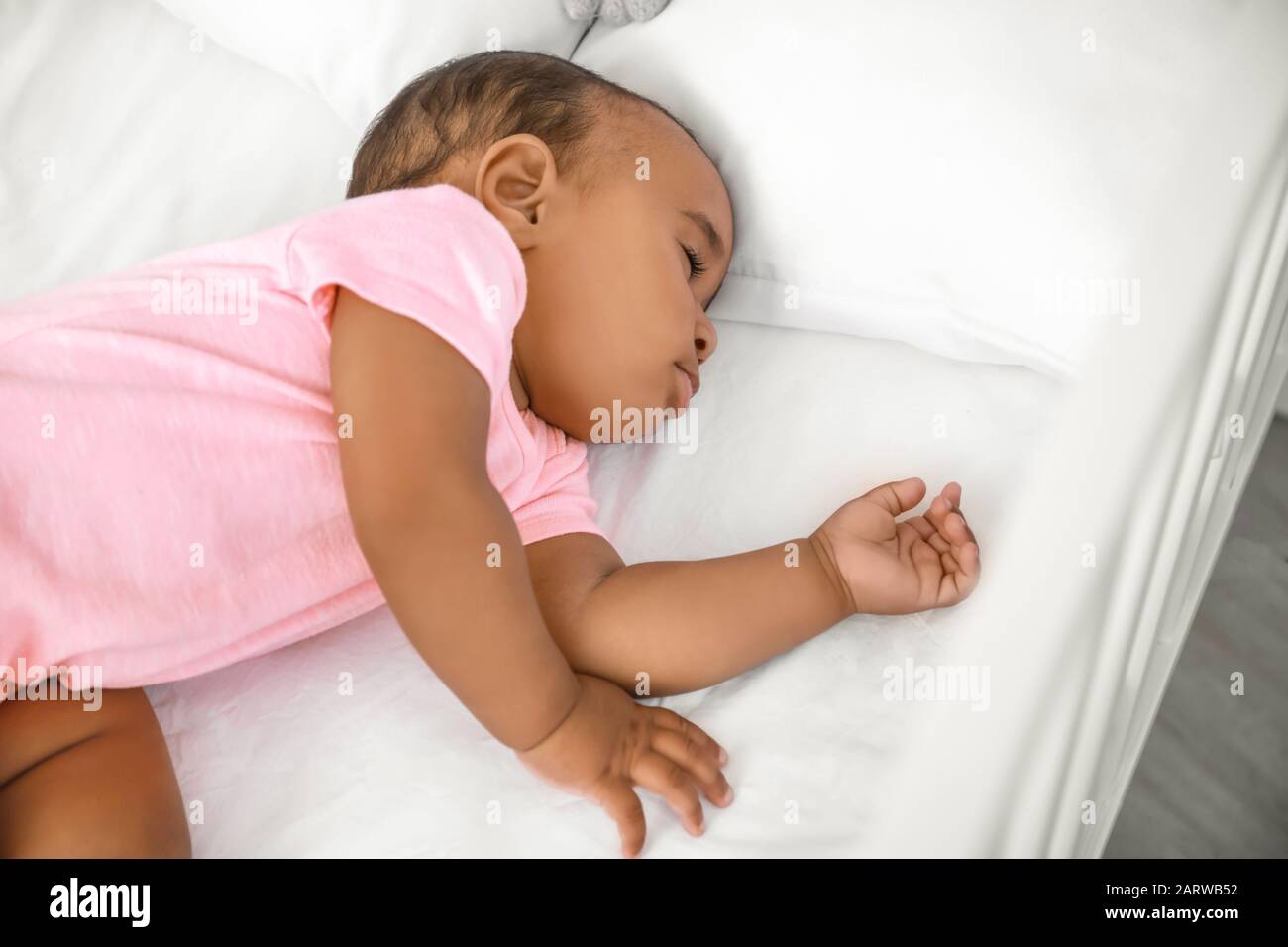 Little African-American baby sleeping in bed Stock Photo - Alamy