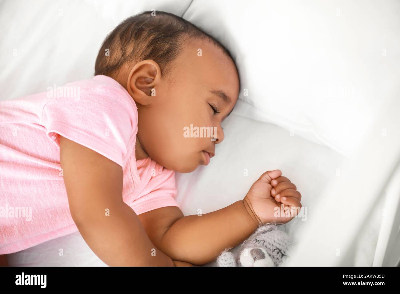 Little African-American baby sleeping in bed Stock Photo - Alamy