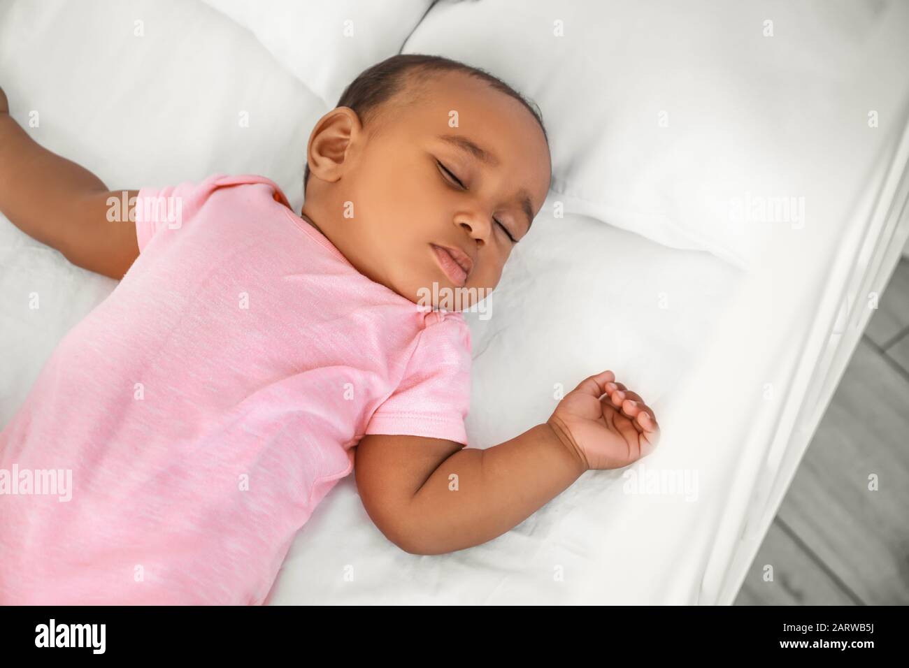 Little African-American baby sleeping in bed Stock Photo - Alamy