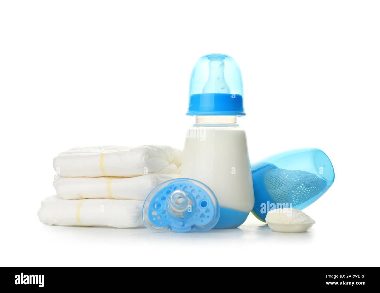Bottle of baby milk formula with pacifier, diapers and nibbler on white ...