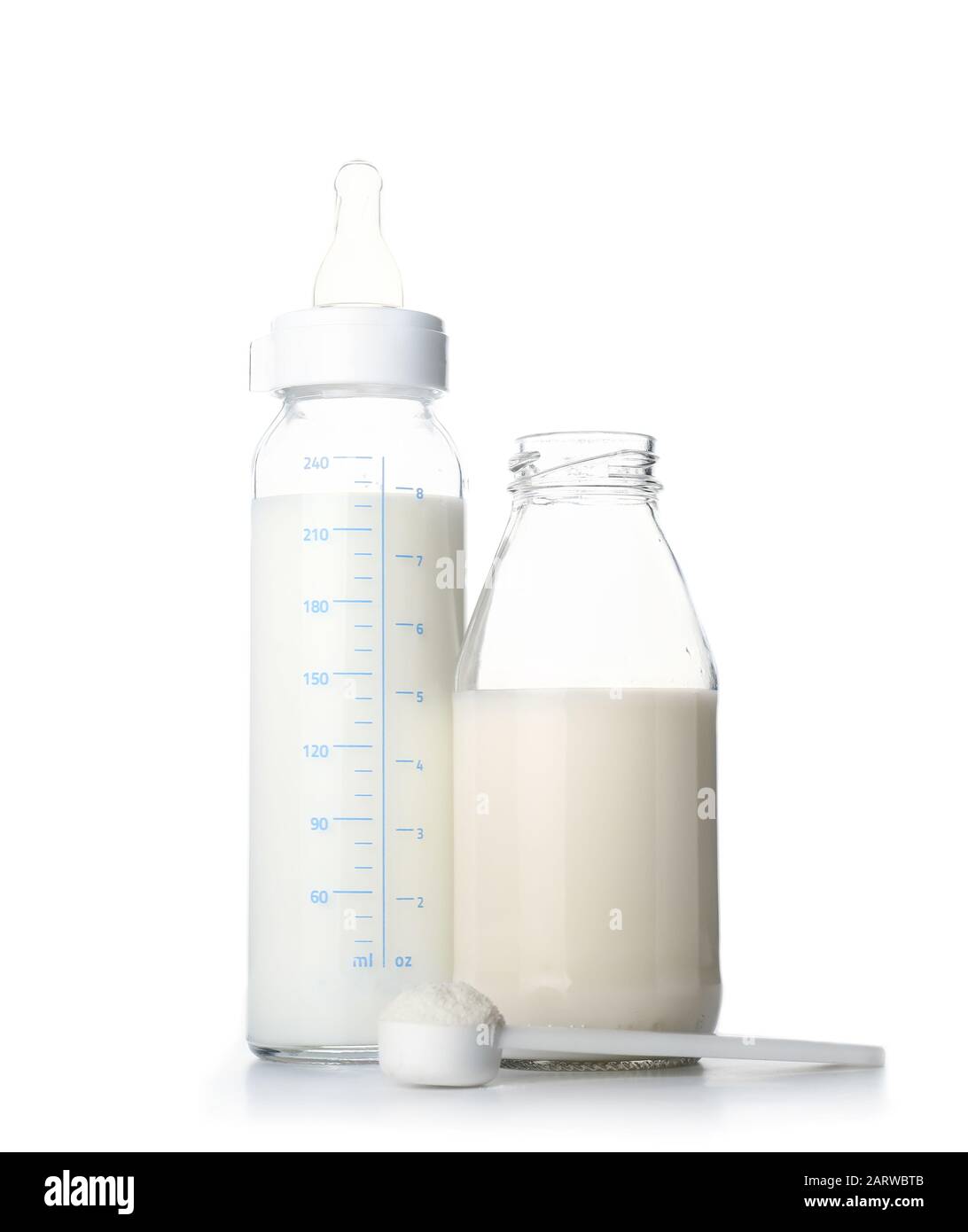 Bottles of baby milk formula on white background Stock Photo - Alamy