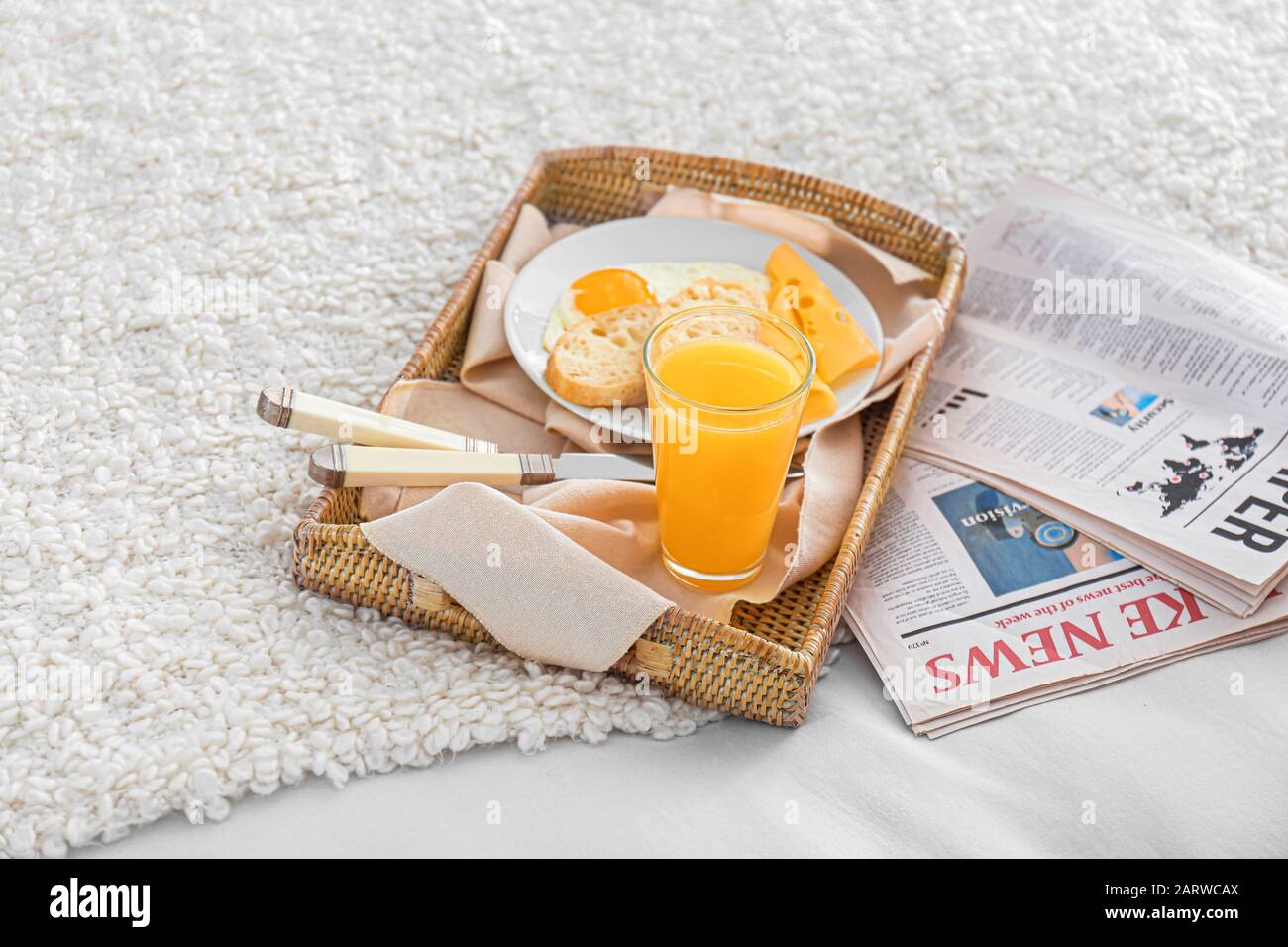 Tray with tasty breakfast and newspapers on bed Stock Photo - Alamy