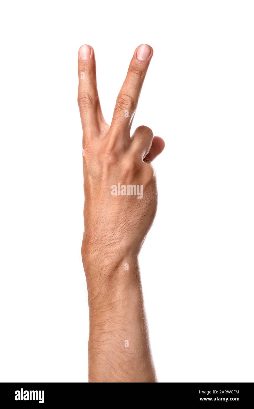 Male hand showing victory gesture on white background Stock Photo - Alamy