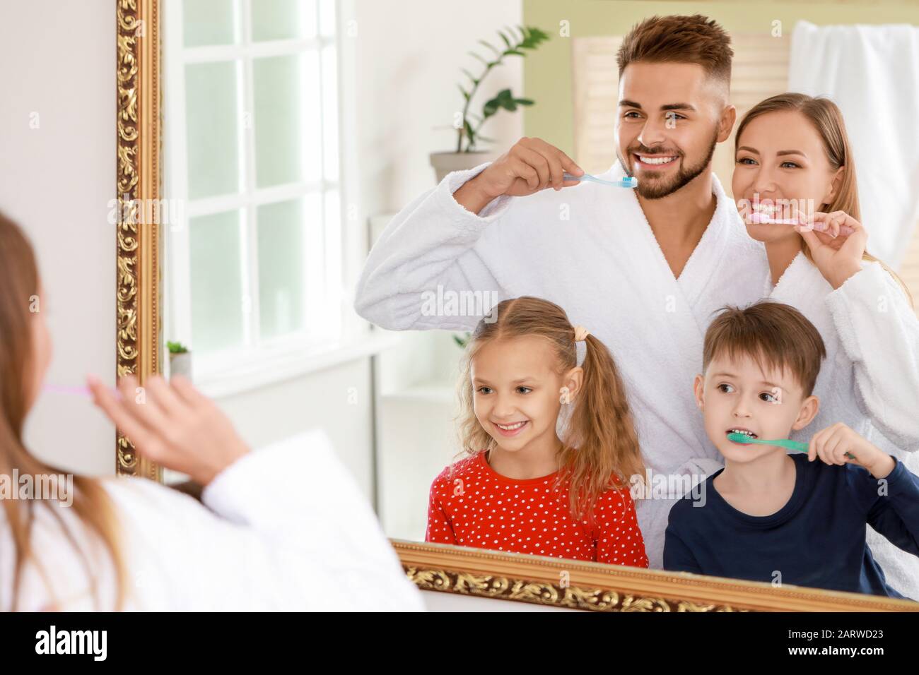 Family brushing teeth in bathroom Stock Photo - Alamy