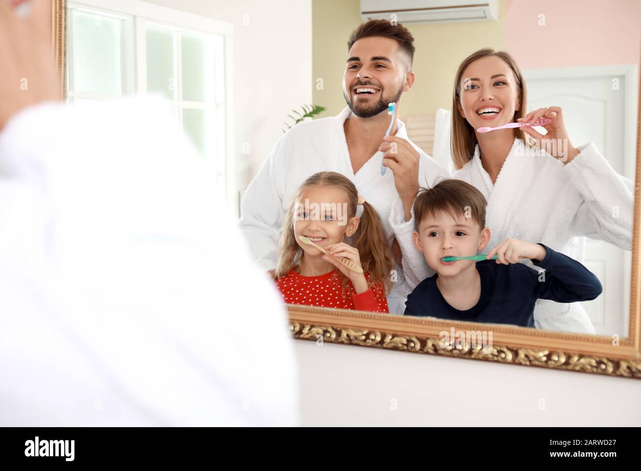 Family brushing teeth in bathroom Stock Photo - Alamy