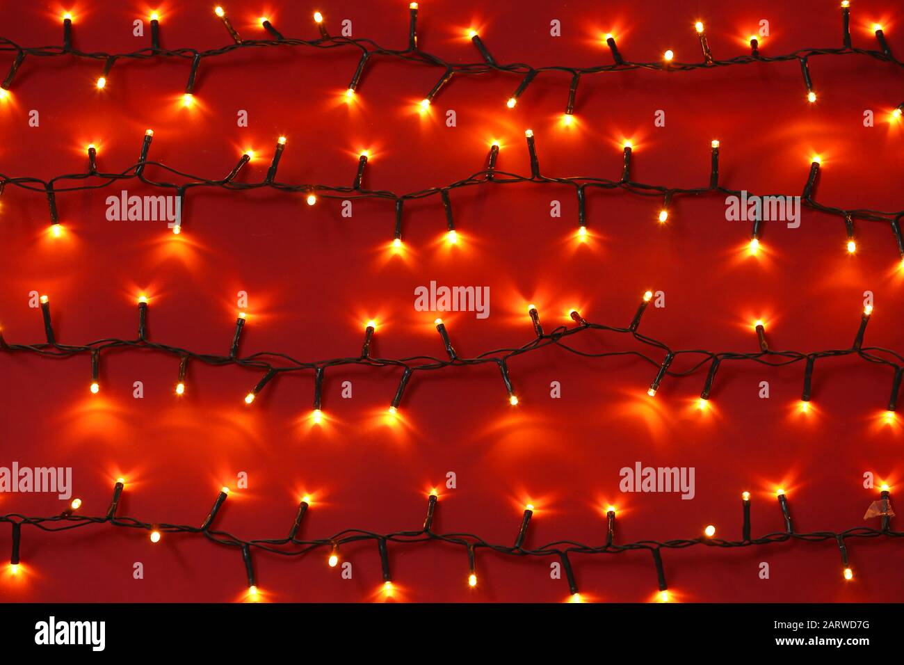 Beautiful Christmas lights on color background Stock Photo - Alamy