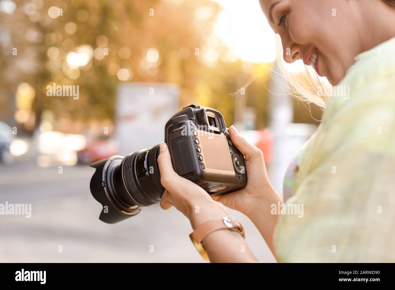 Beautiful female photographer working outdoors Stock Photo - Alamy