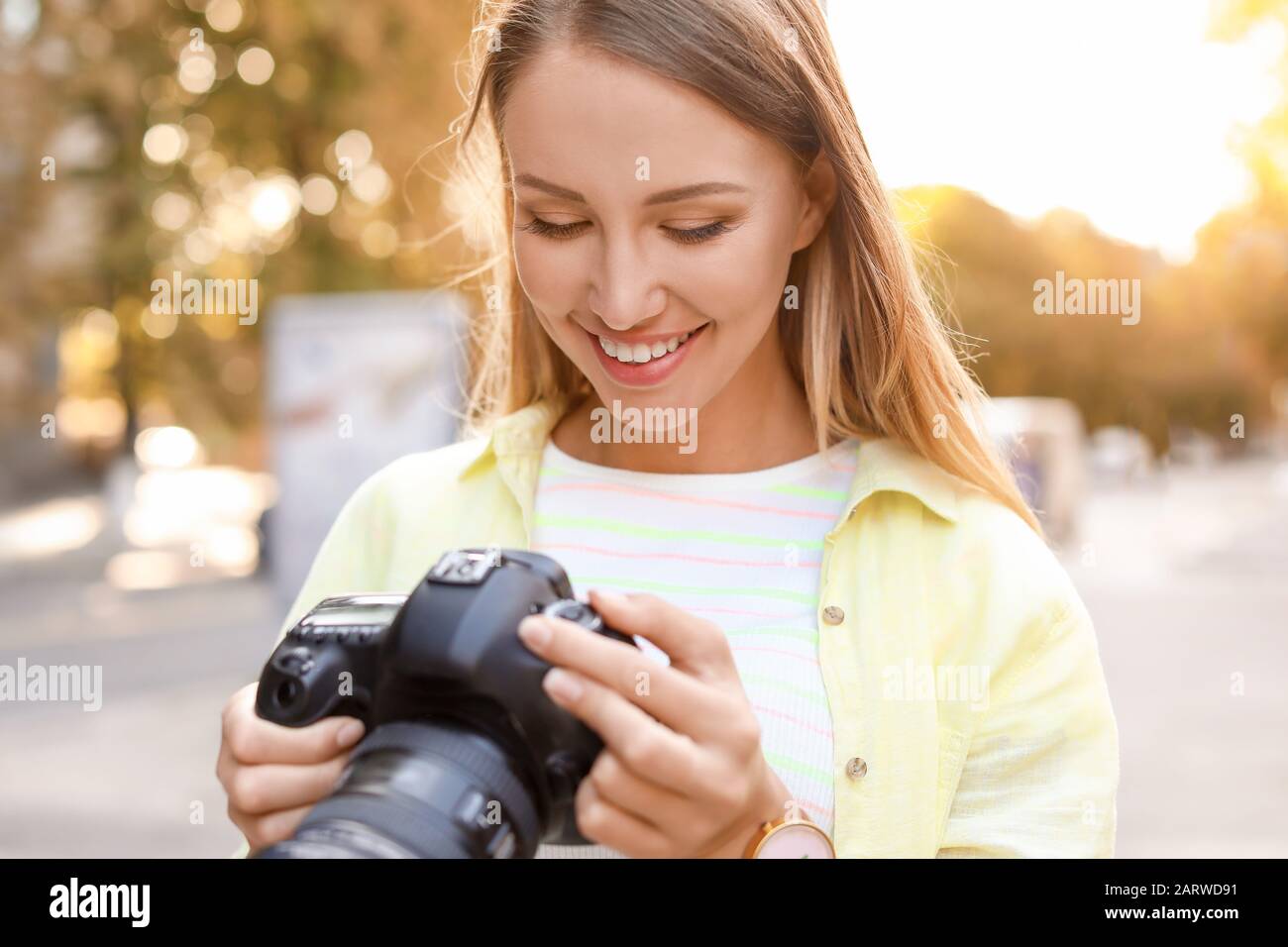 Beautiful female photographer working outdoors Stock Photo - Alamy