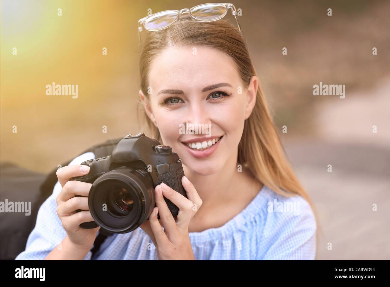 Beautiful female photographer working outdoors Stock Photo - Alamy