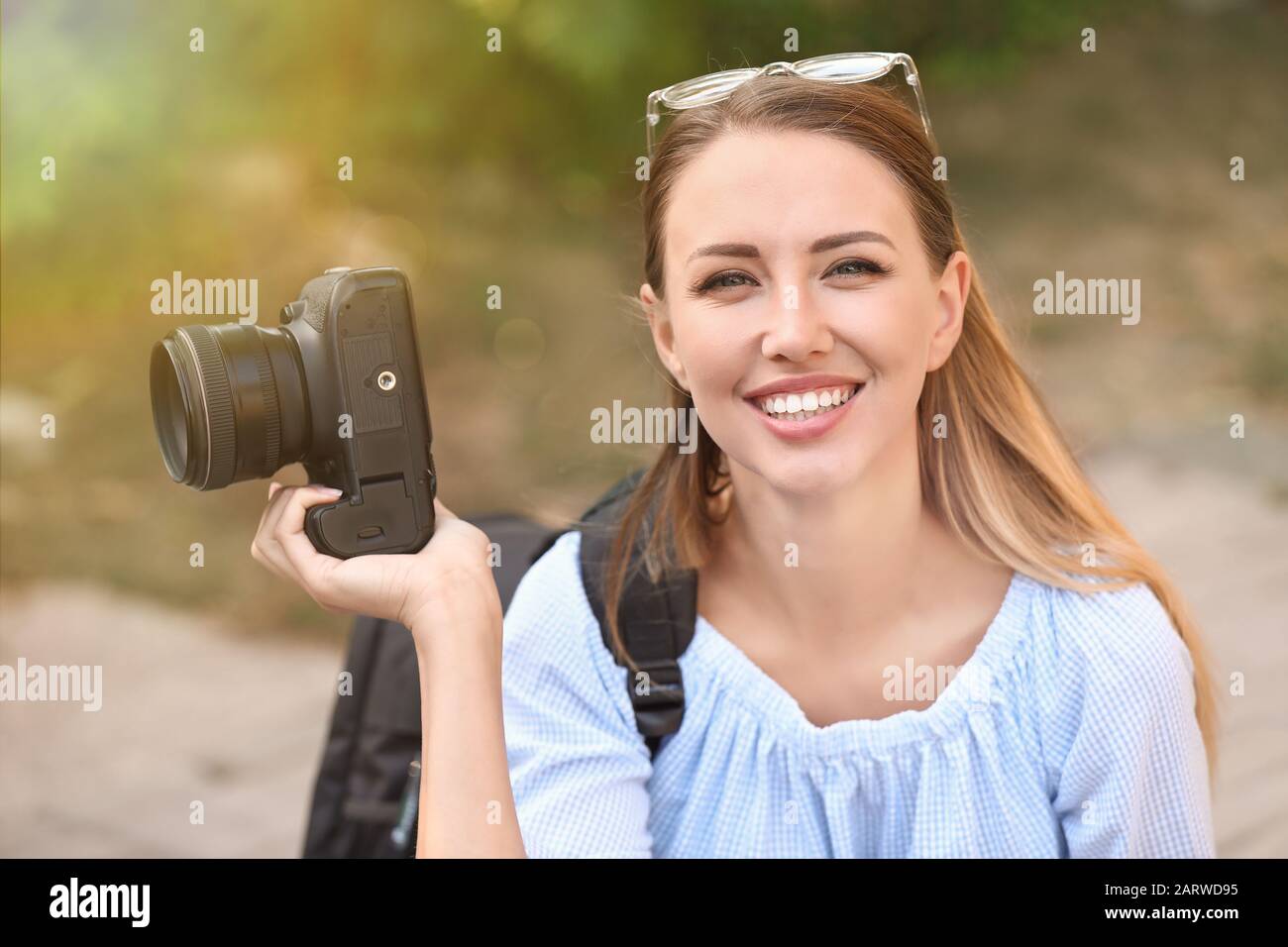 Beautiful female photographer working outdoors Stock Photo - Alamy