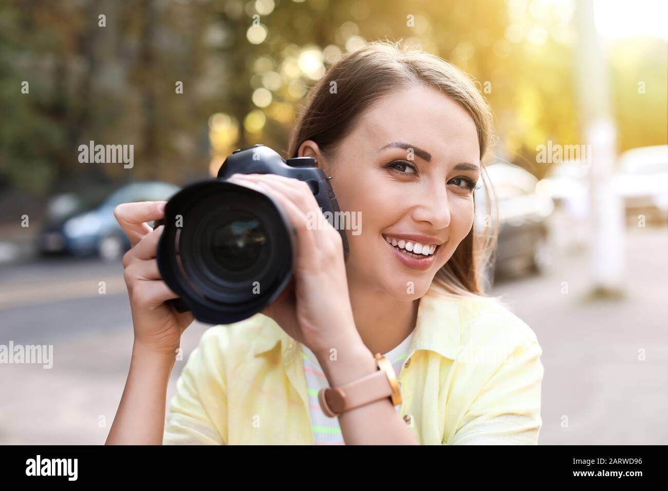 Beautiful female photographer working outdoors Stock Photo - Alamy