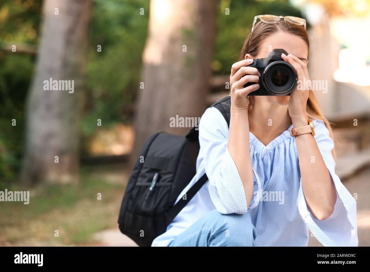 Beautiful female photographer working outdoors Stock Photo - Alamy