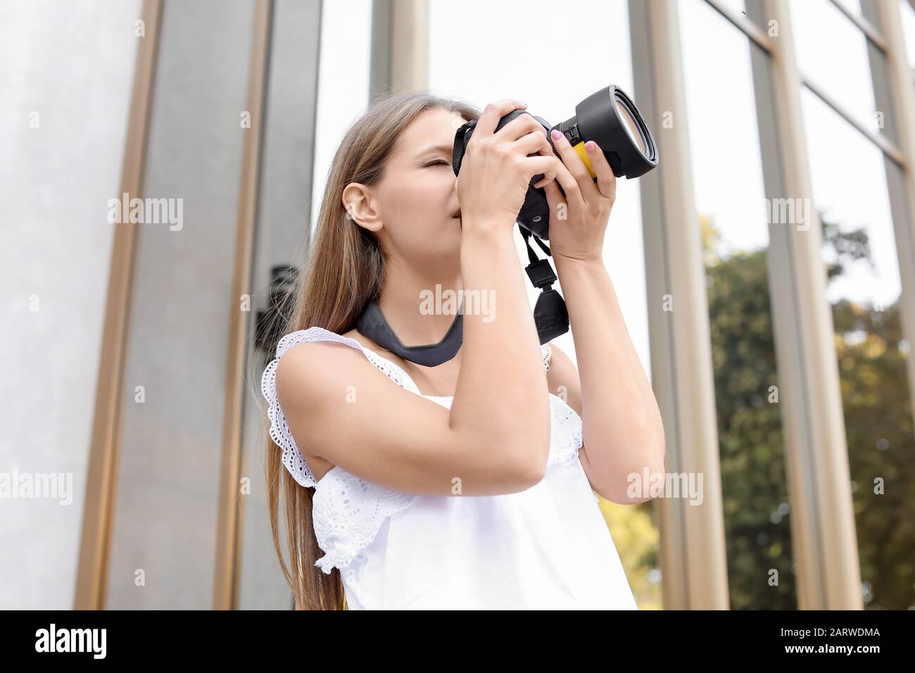 Beautiful female photographer with camera outdoors Stock Photo - Alamy