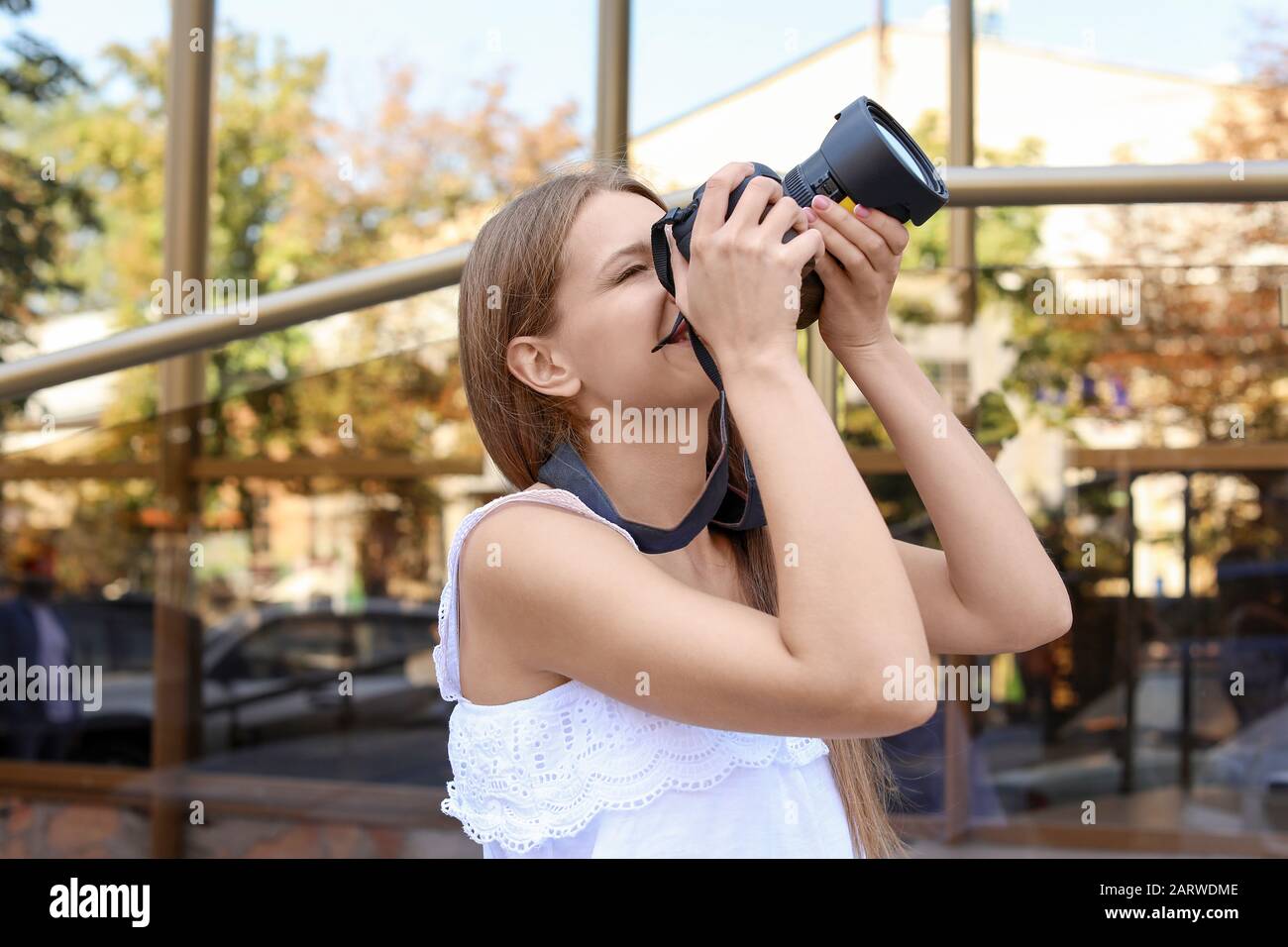 Beautiful female photographer with camera outdoors Stock Photo - Alamy