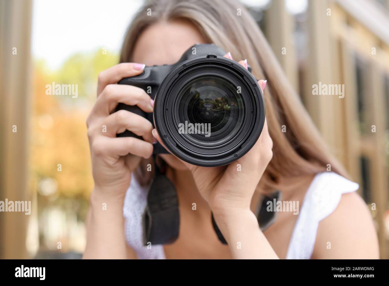 Beautiful female photographer with camera outdoors Stock Photo - Alamy