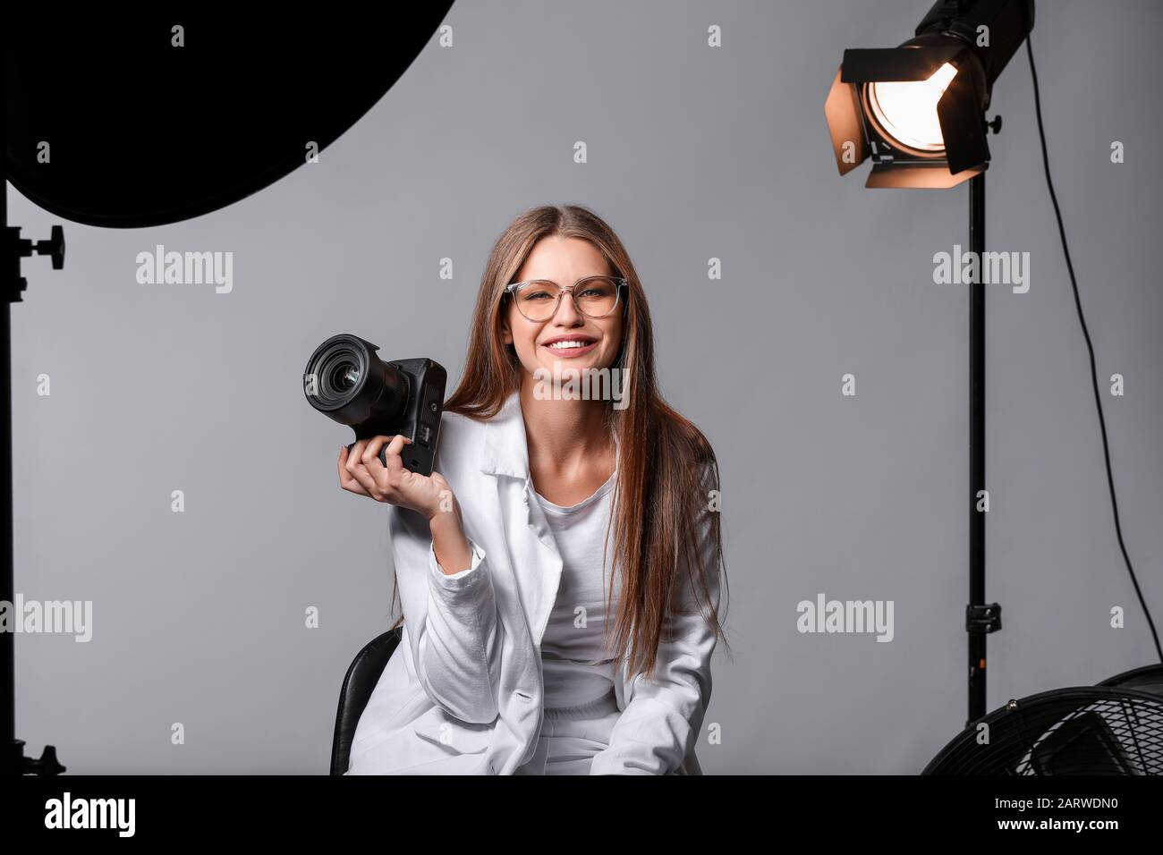 Beautiful female photographer in studio Stock Photo - Alamy