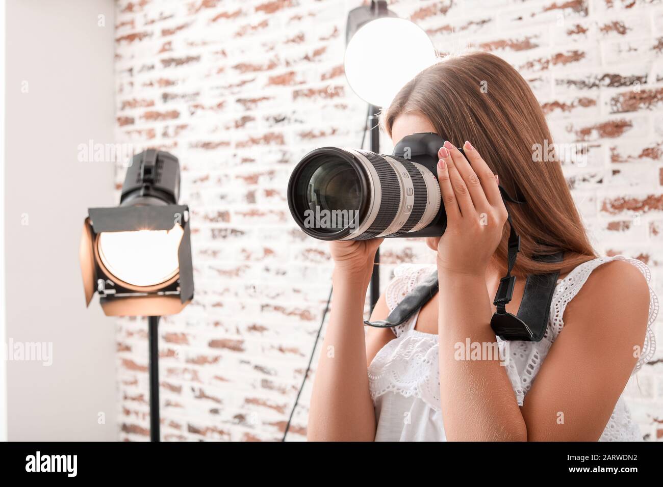 Beautiful female photographer in studio Stock Photo - Alamy