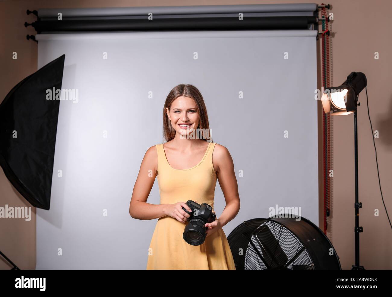 Beautiful female photographer in studio Stock Photo - Alamy