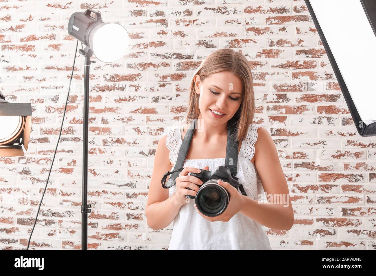 Beautiful female photographer in studio Stock Photo - Alamy