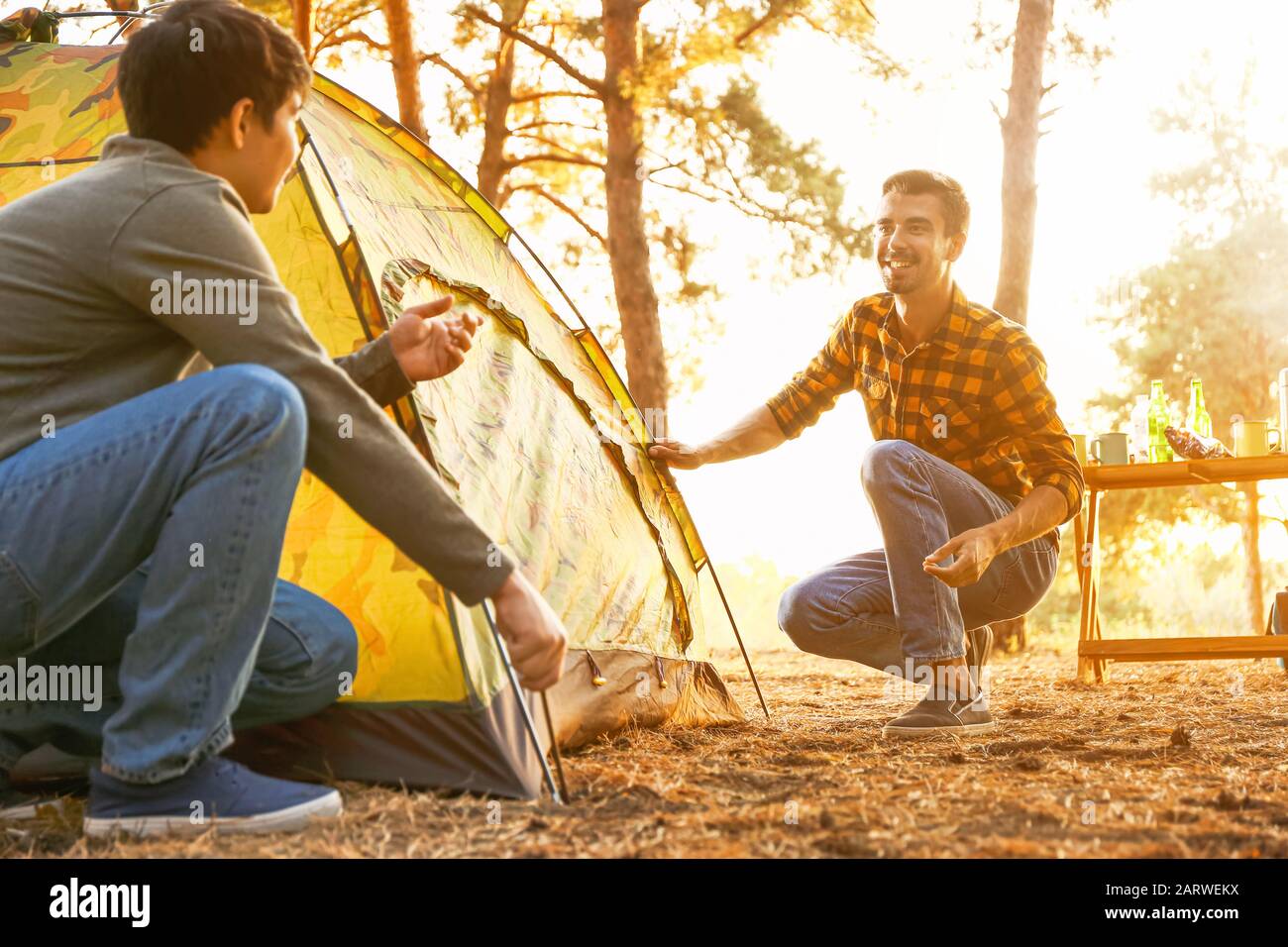 Man putting up tent hi-res stock photography and images - Alamy