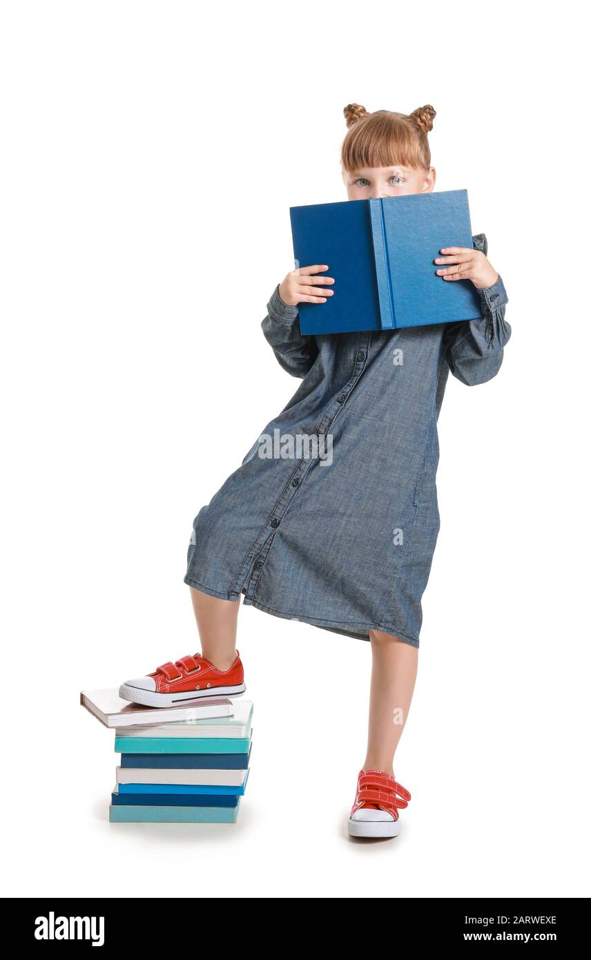 Cute little girl with books on white background Stock Photo - Alamy