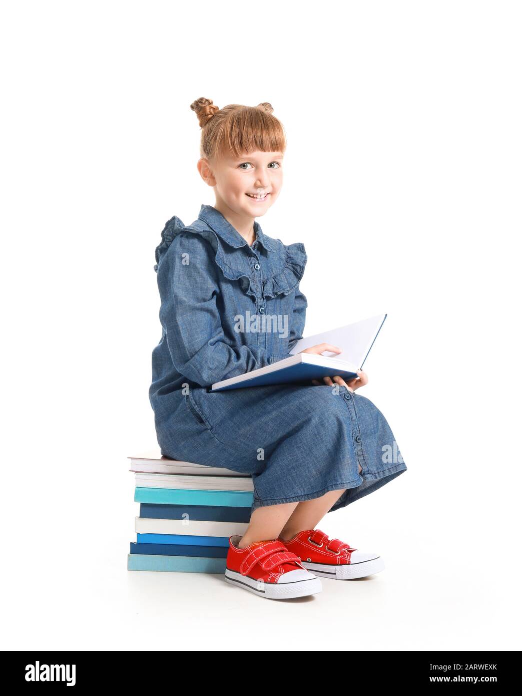 Cute little girl with books on white background Stock Photo - Alamy