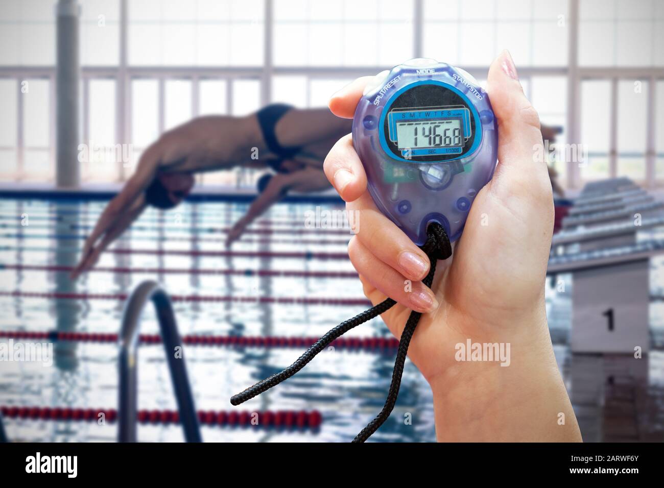 Composite image of close up of a hand holding a timer on a white ...