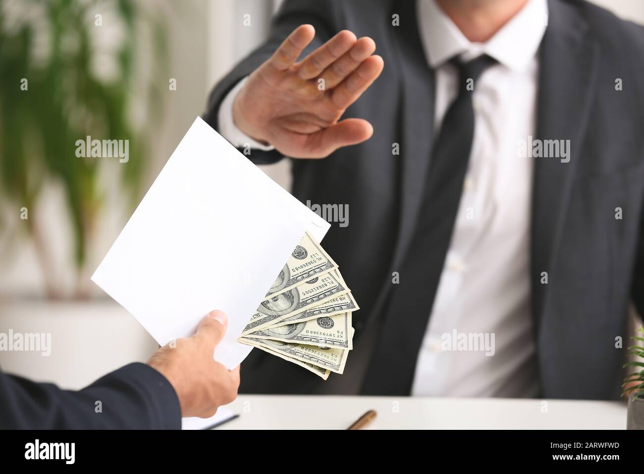 Businessman refusing to take bribe at workplace Stock Photo - Alamy