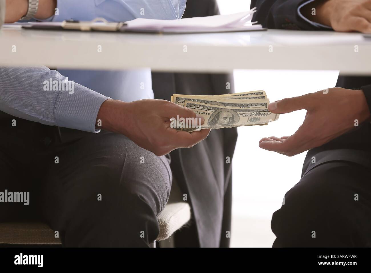 Businessman taking bribe at workplace Stock Photo - Alamy