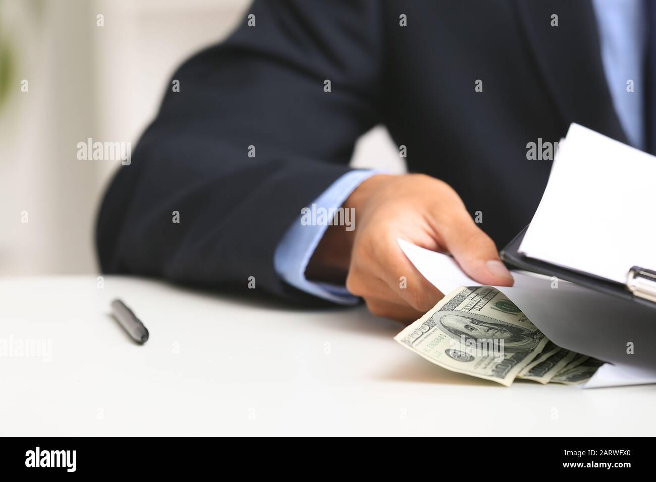 Businessman taking bribe at workplace, closeup Stock Photo - Alamy