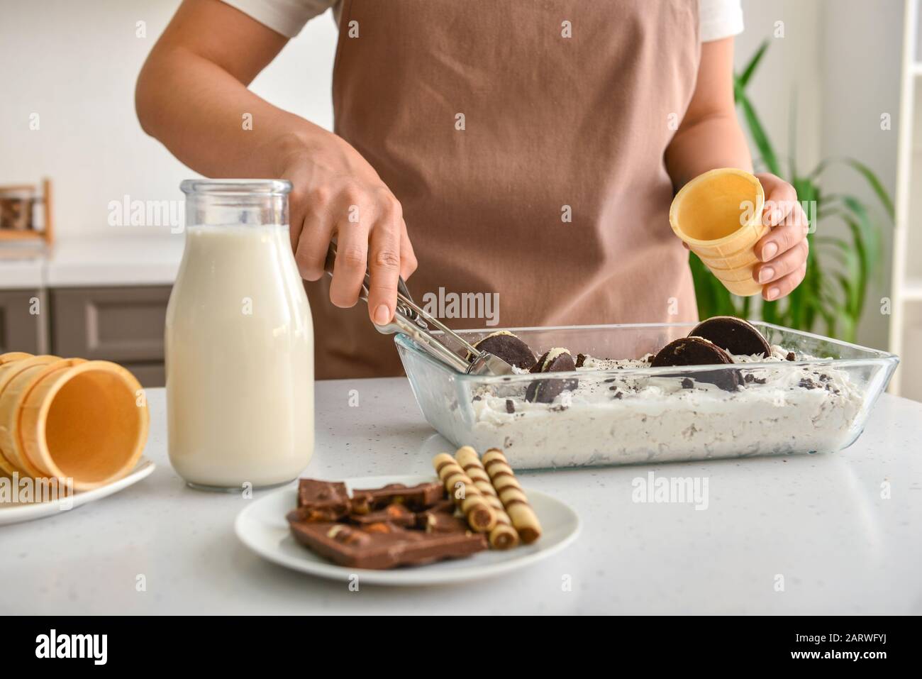 Woman preparing tasty ice cream in kitchen Stock Photo - Alamy