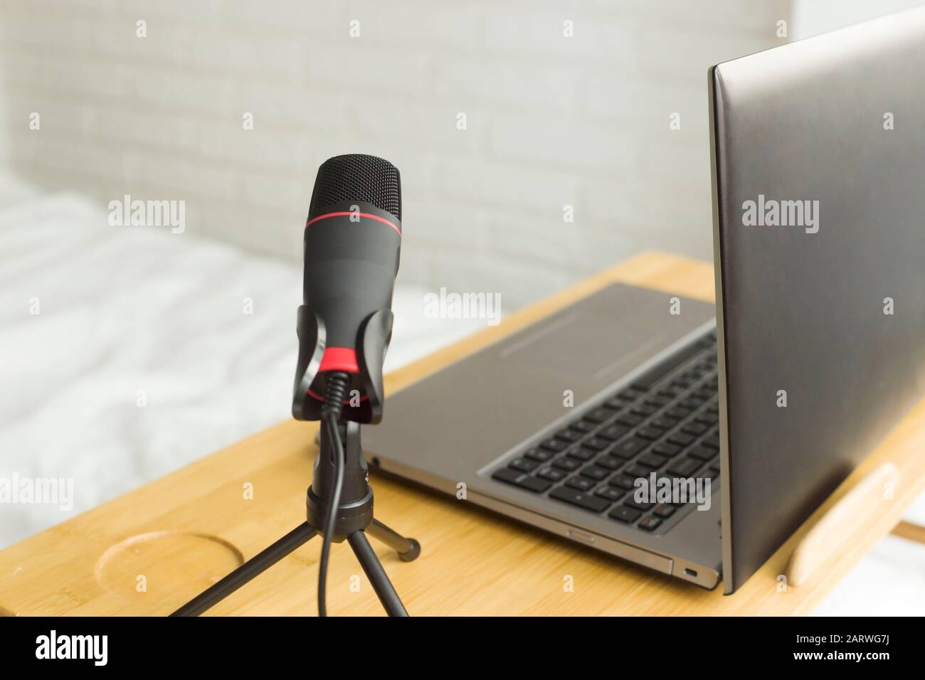 Microphone and laptop on the table for recording podcast at home ...