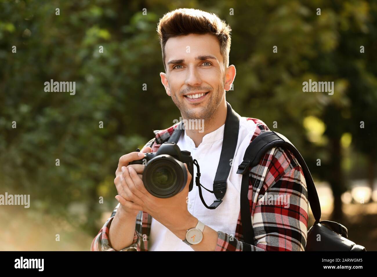Handsome male photographer with camera outdoors Stock Photo - Alamy