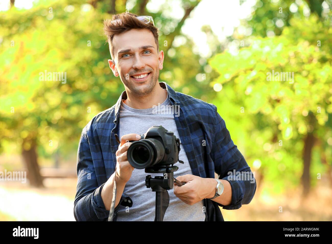 Handsome male photographer with camera outdoors Stock Photo - Alamy