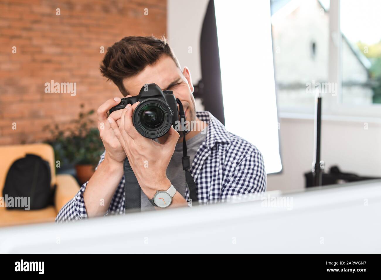 Handsome male photographer in studio Stock Photo - Alamy