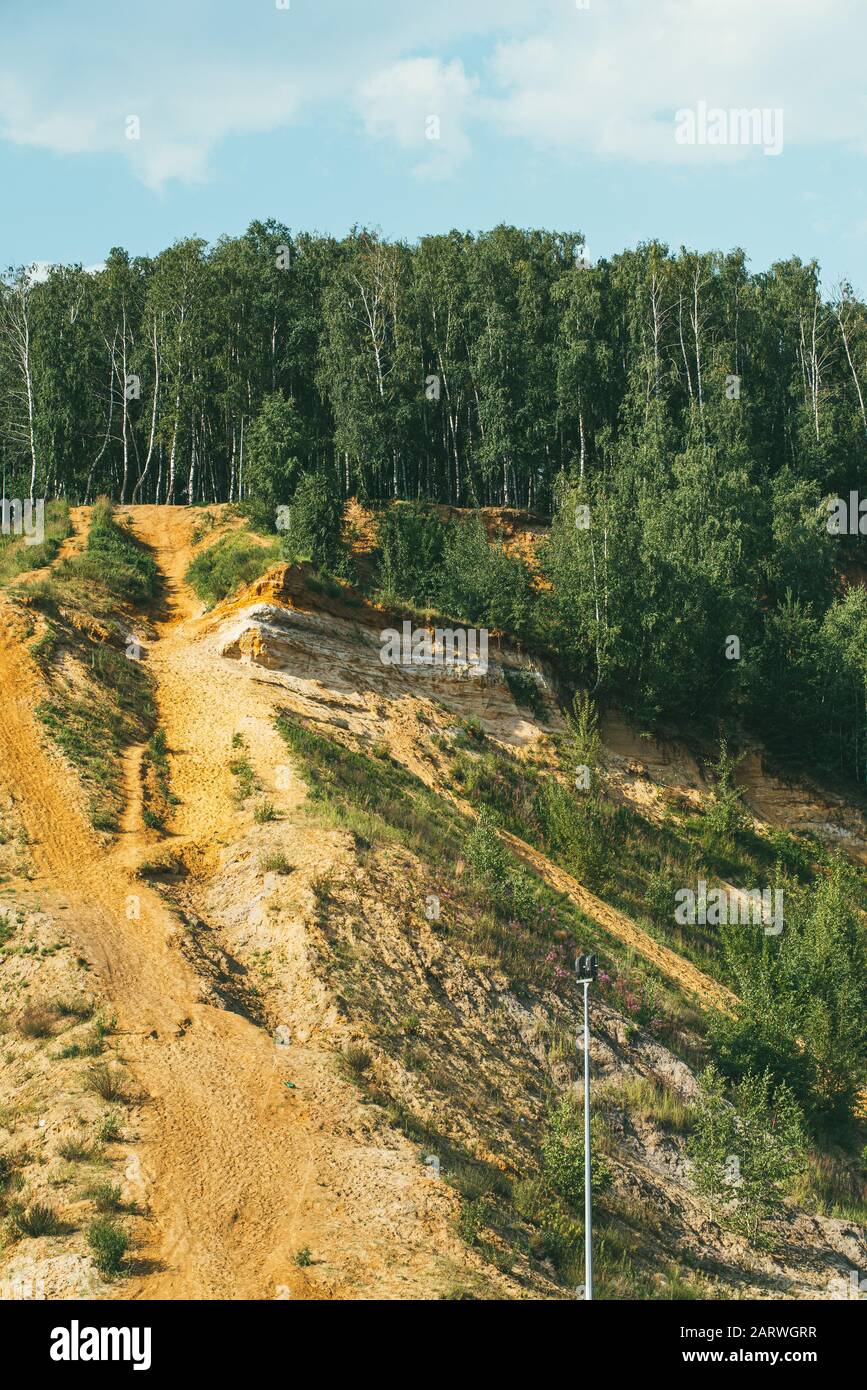 High rocky sandy steep bank covered with pine trees Stock Photo - Alamy