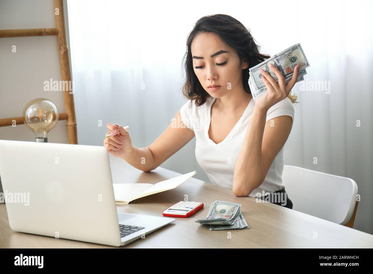 Asian woman counting money hi-res stock photography and images - Alamy