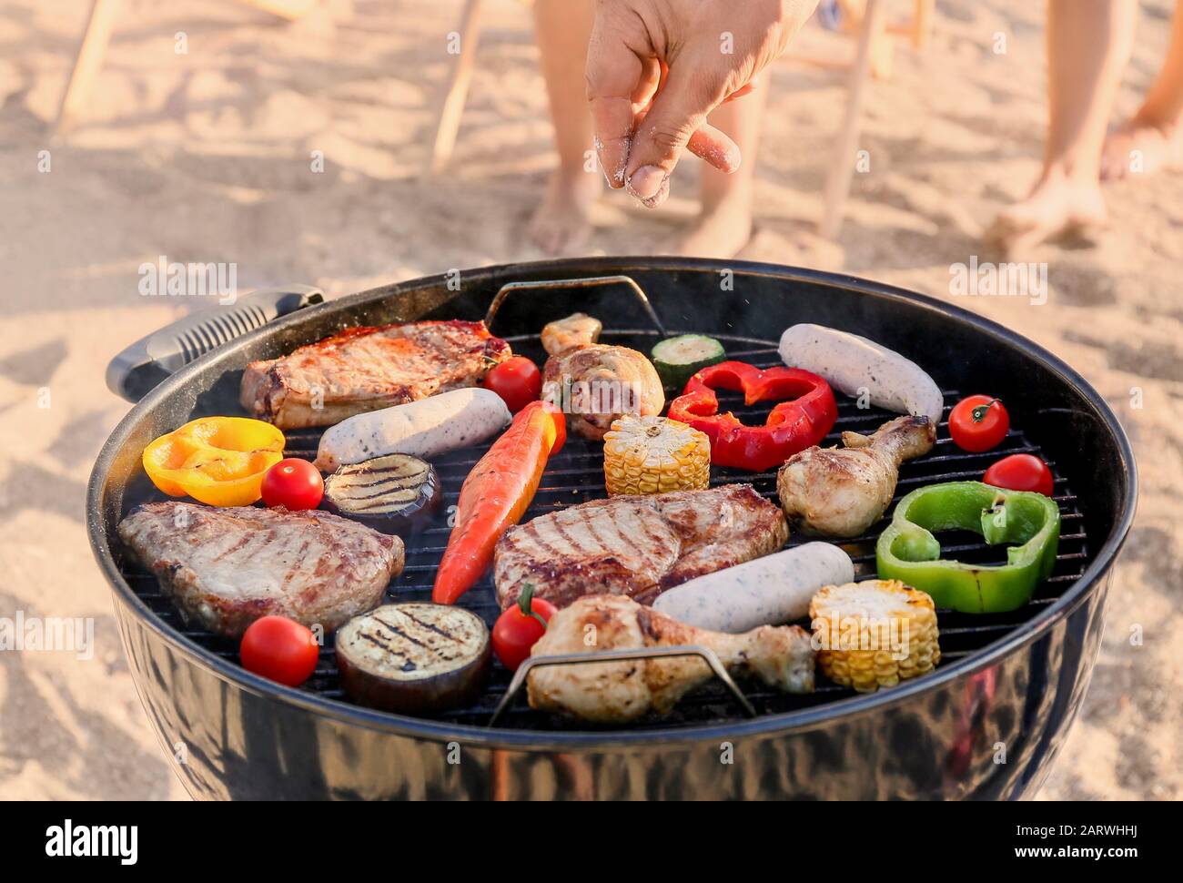 Man cooking tasty food on barbecue grill outdoors, closeup Stock Photo ...
