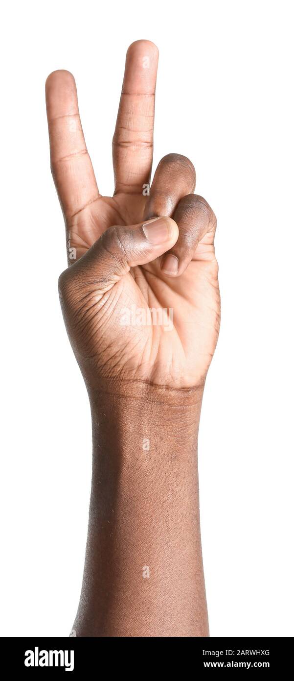 Hand of African-American man showing victory gesture on white ...
