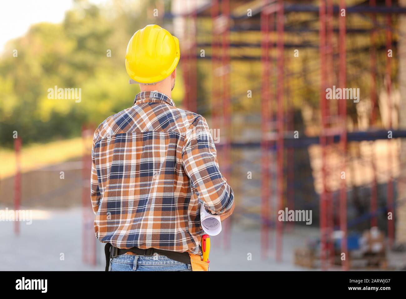 Male architect in building area, back view Stock Photo - Alamy