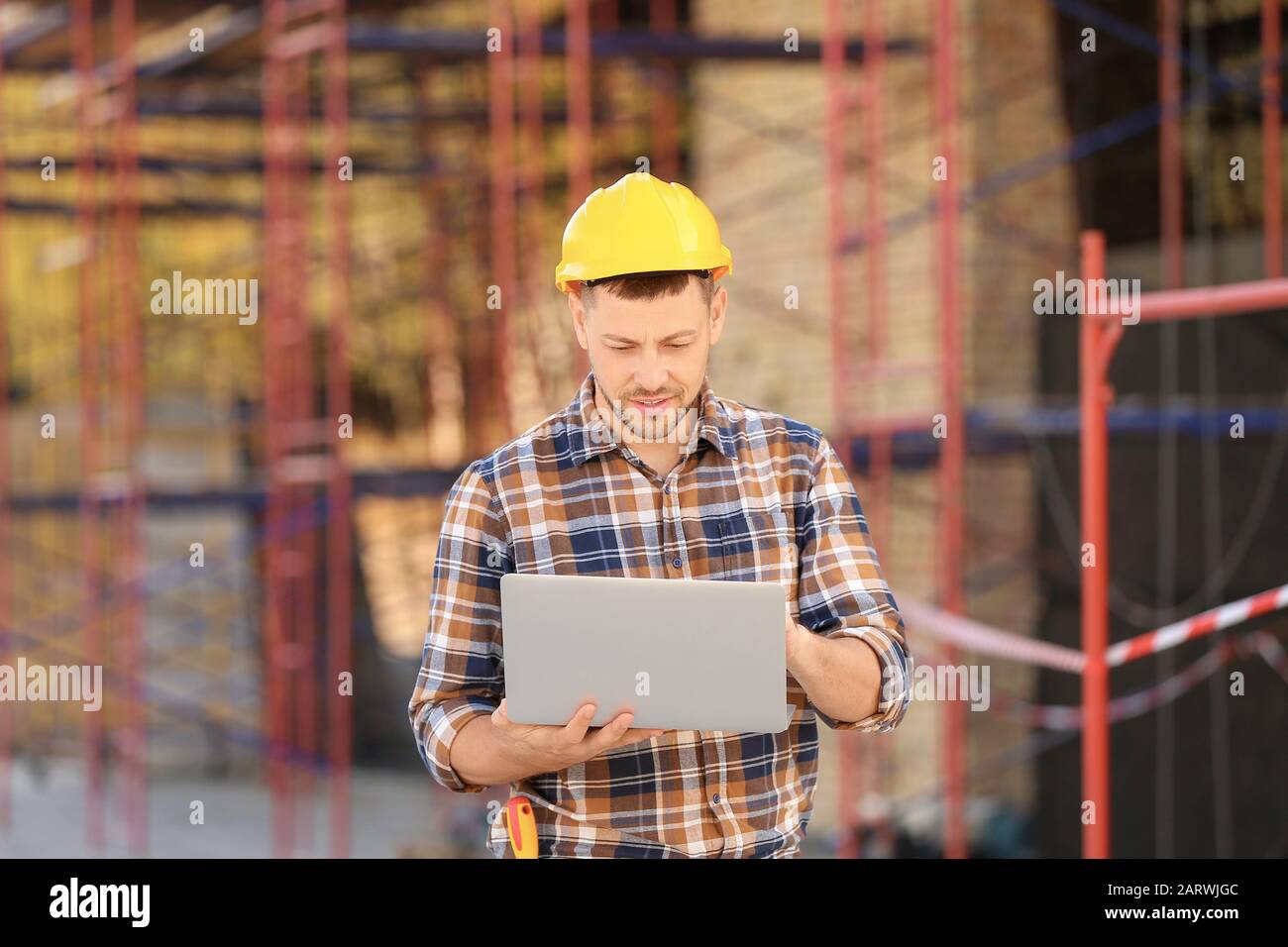 Portrait of male architect with laptop in building area Stock Photo - Alamy
