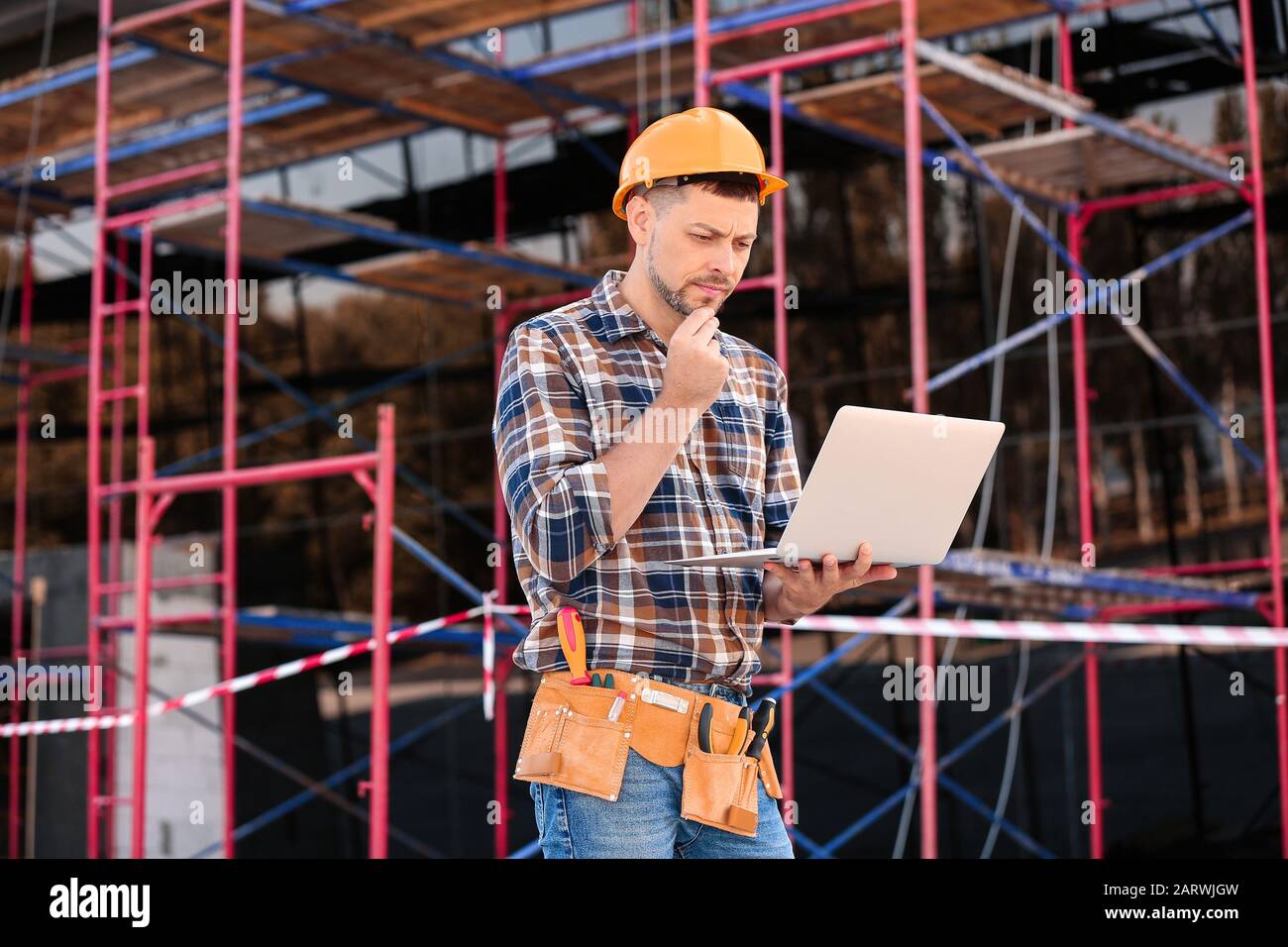 Portrait of male architect with laptop in building area Stock Photo - Alamy