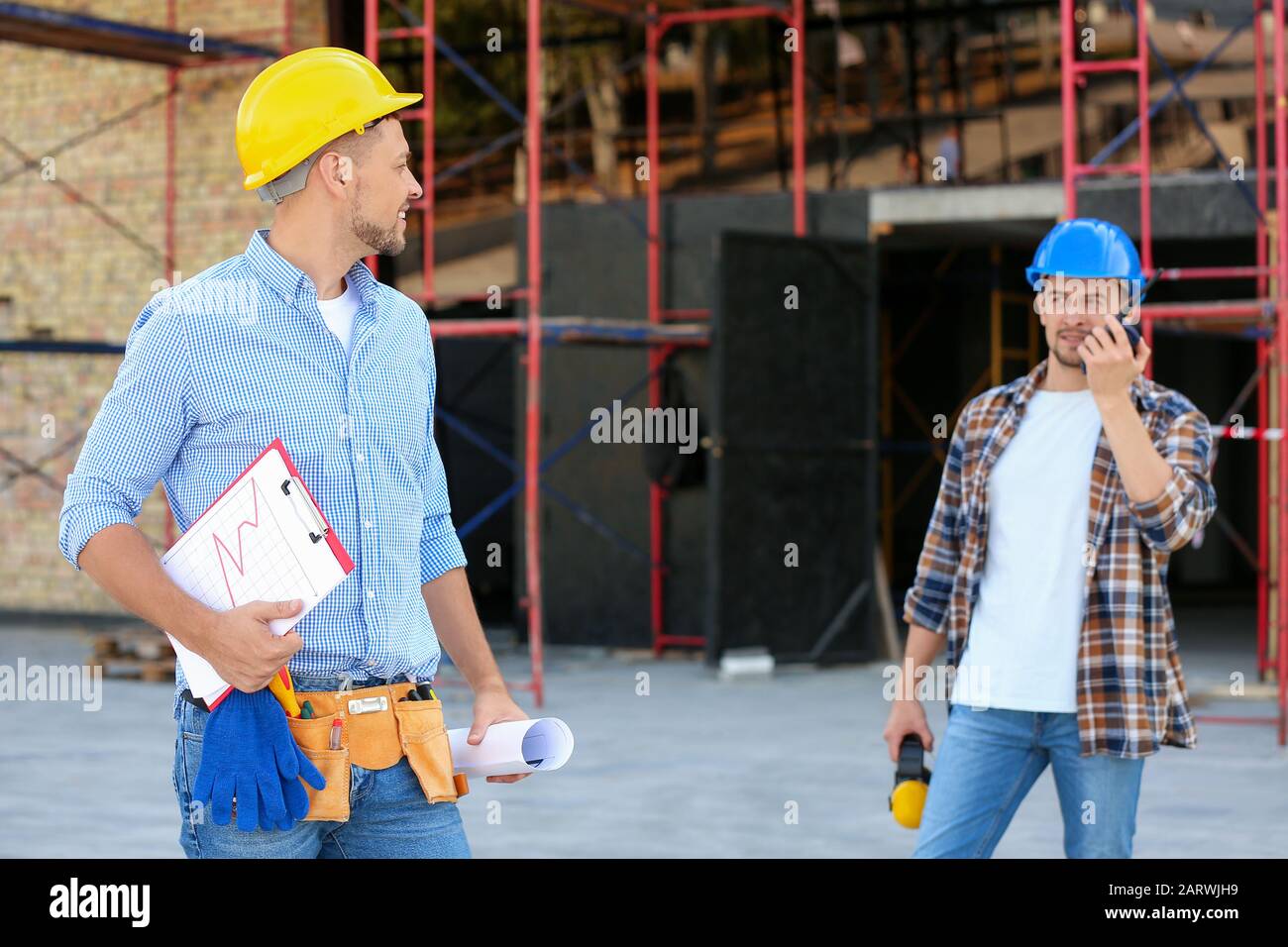 Male architects working in building area Stock Photo - Alamy