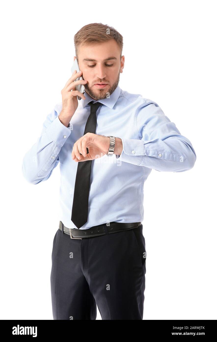 Portrait of handsome businessman looking at watch while talking by ...
