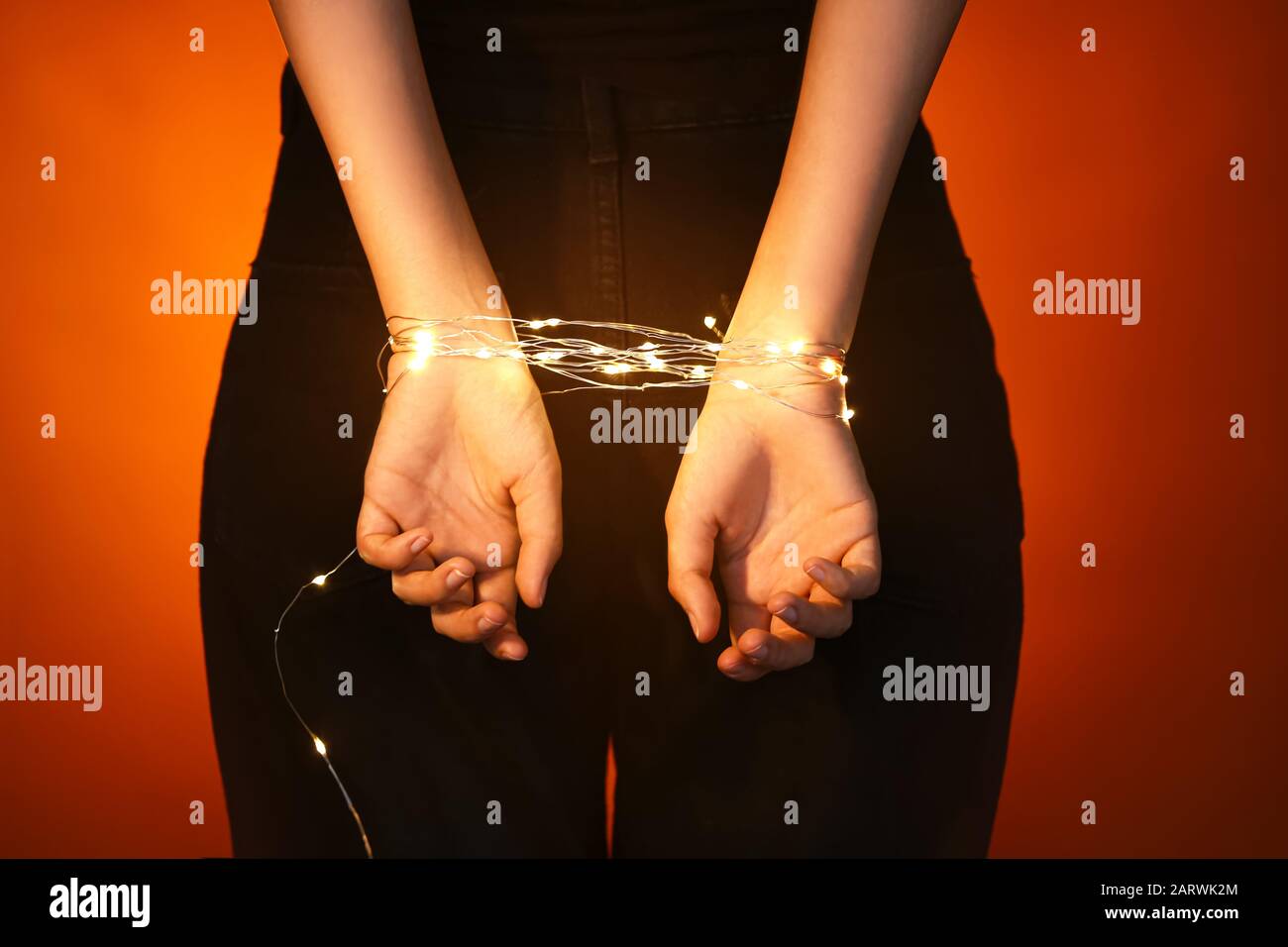 Christmas lights wound on woman's hands, closeup Stock Photo - Alamy