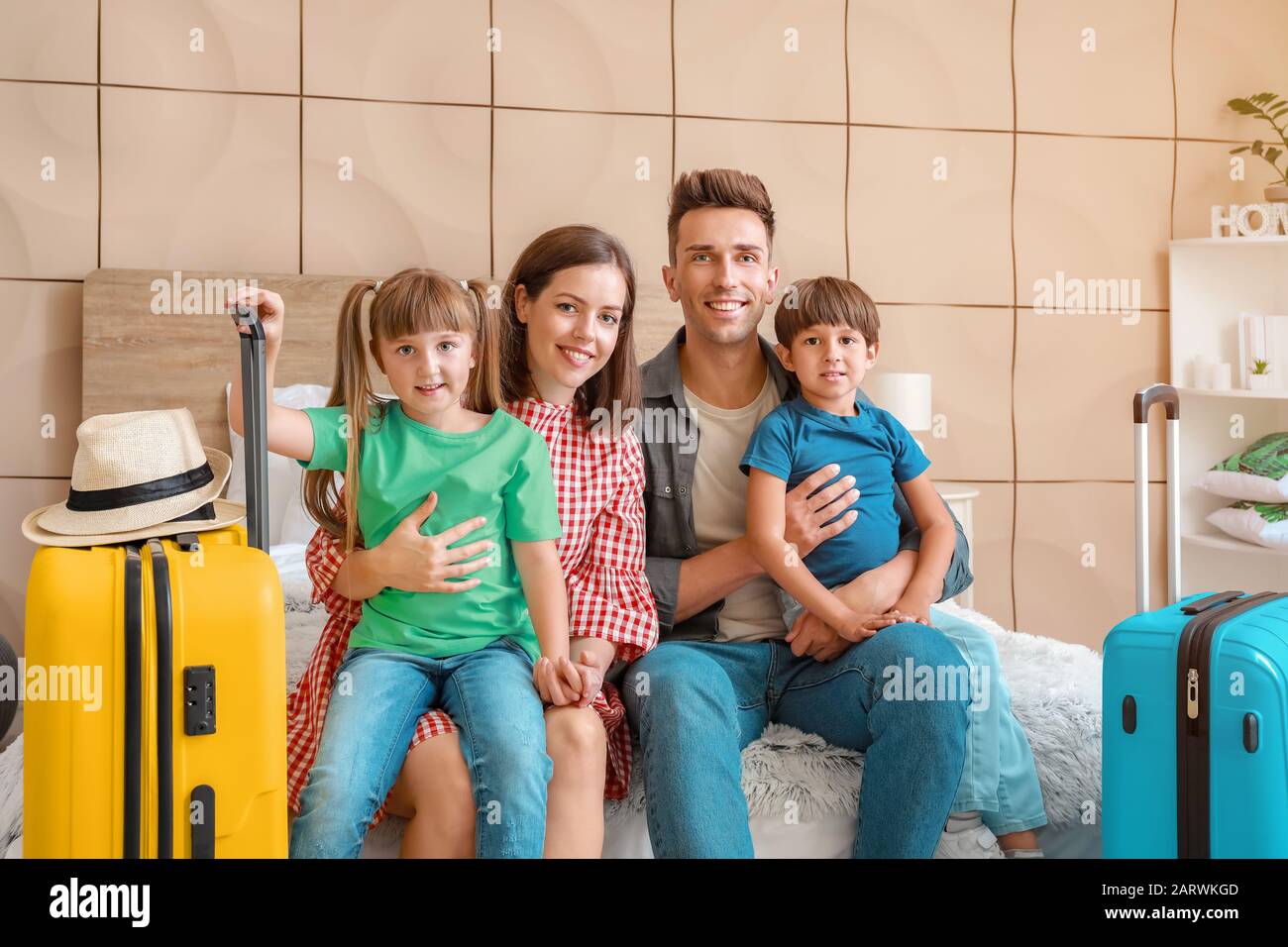 Happy family with packed suitcases at home Stock Photo - Alamy