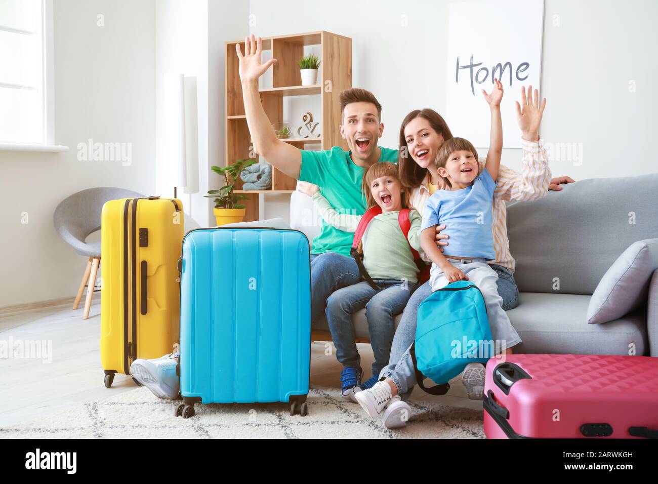 Happy family with packed suitcases at home Stock Photo - Alamy
